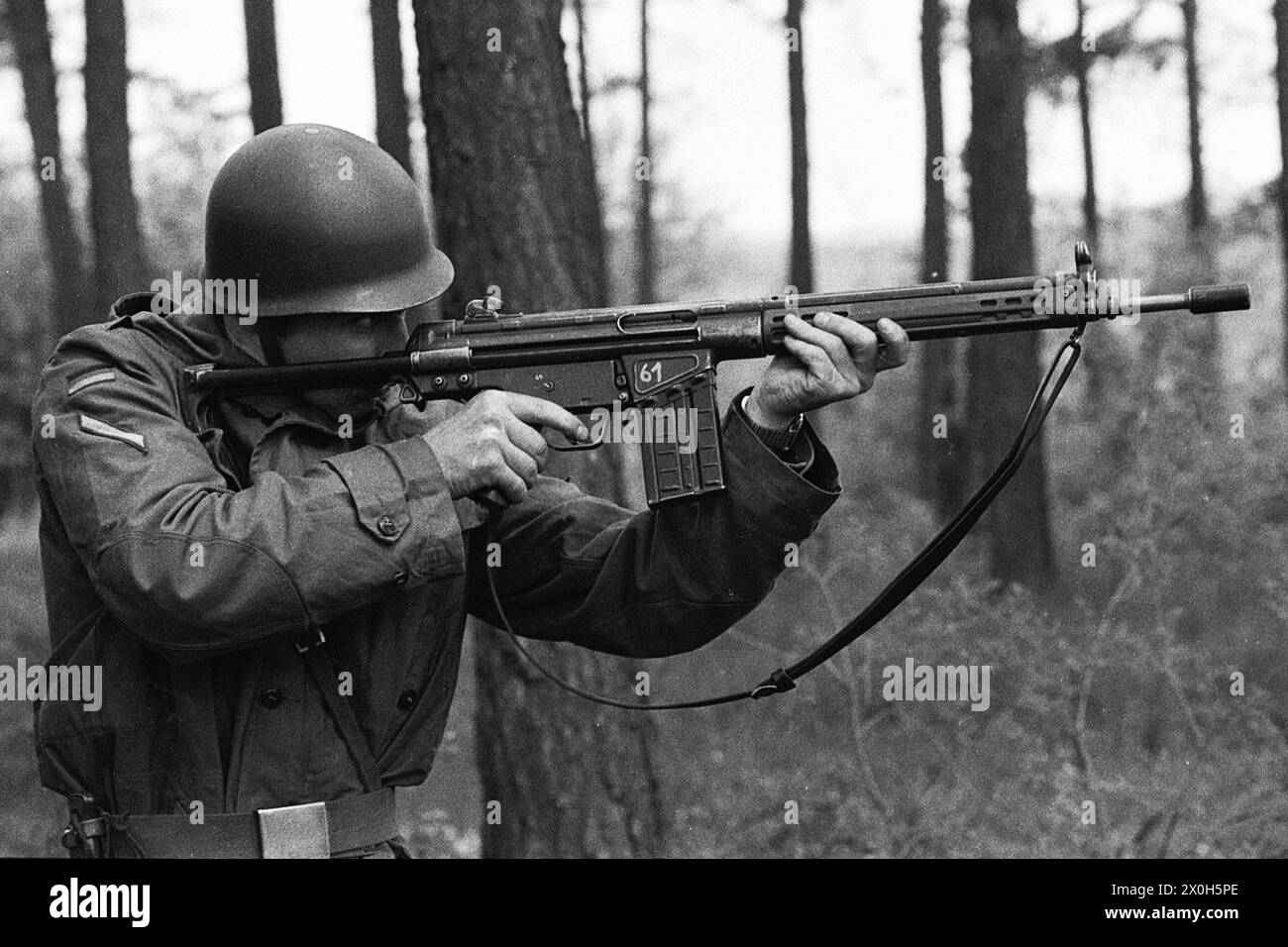 Troop exercise: A soldier takes aim with an assault rifle. [automated ...