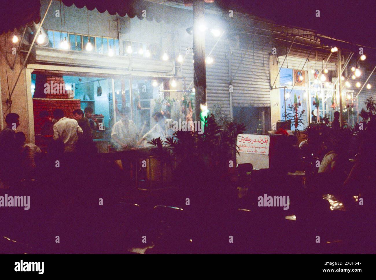 Smoking barbecues and loud nightlife in a street bar in Homs, Syria ...