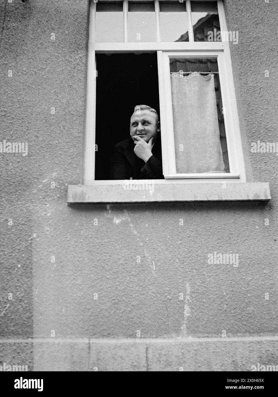 A man looks out of the window with satisfaction. [automated translation ...