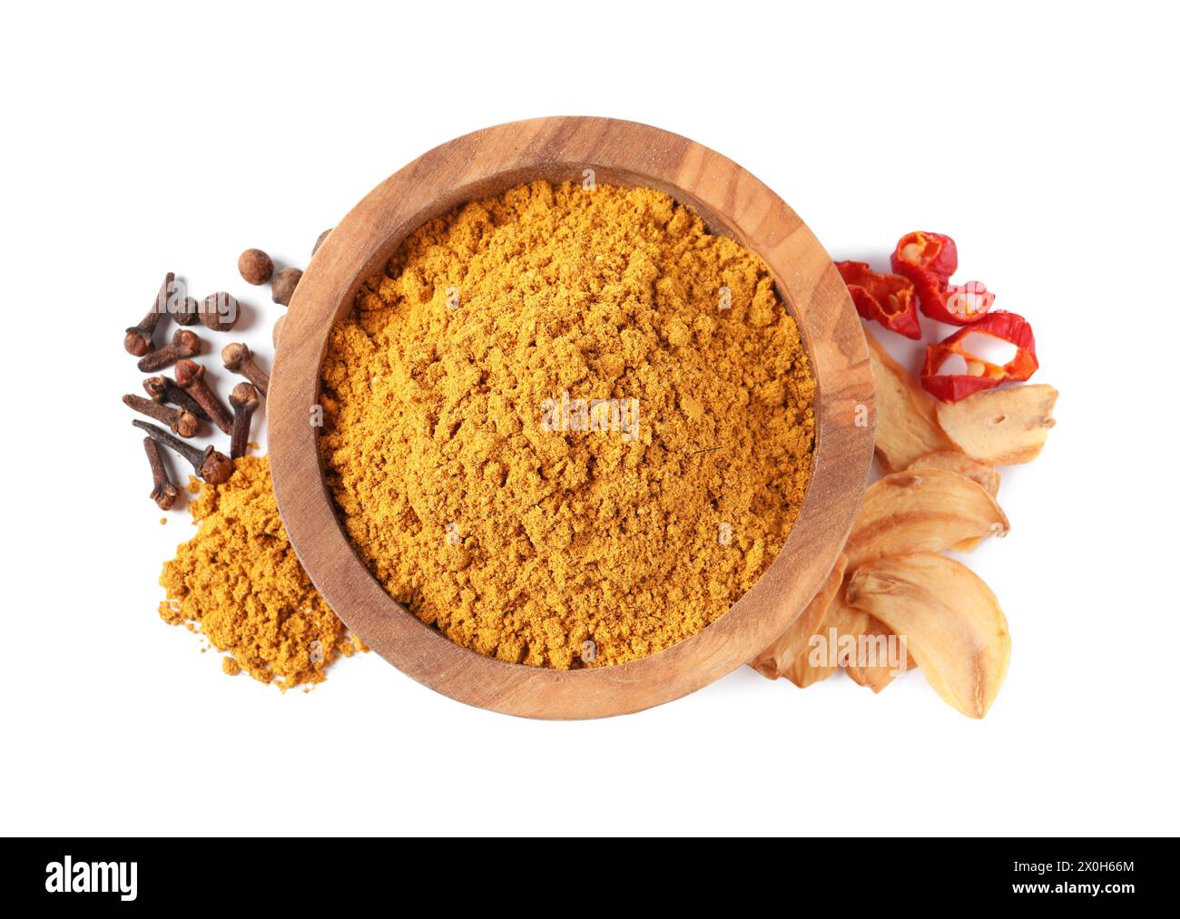 Dry curry powder in bowl and other spices isolated on white, top view ...