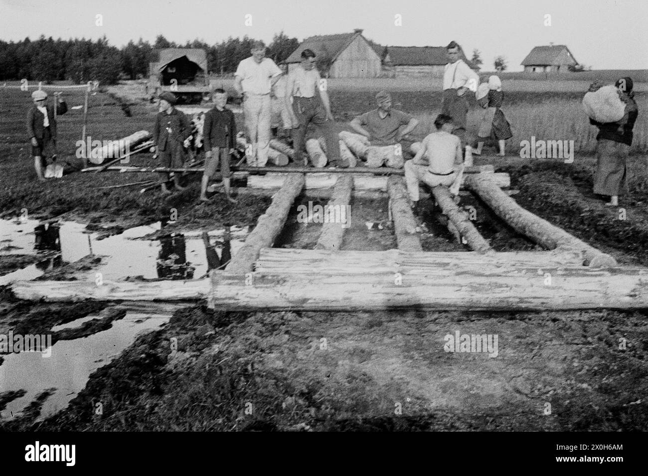 On the eastern front, a boulder dam is built with logs so that the road ...