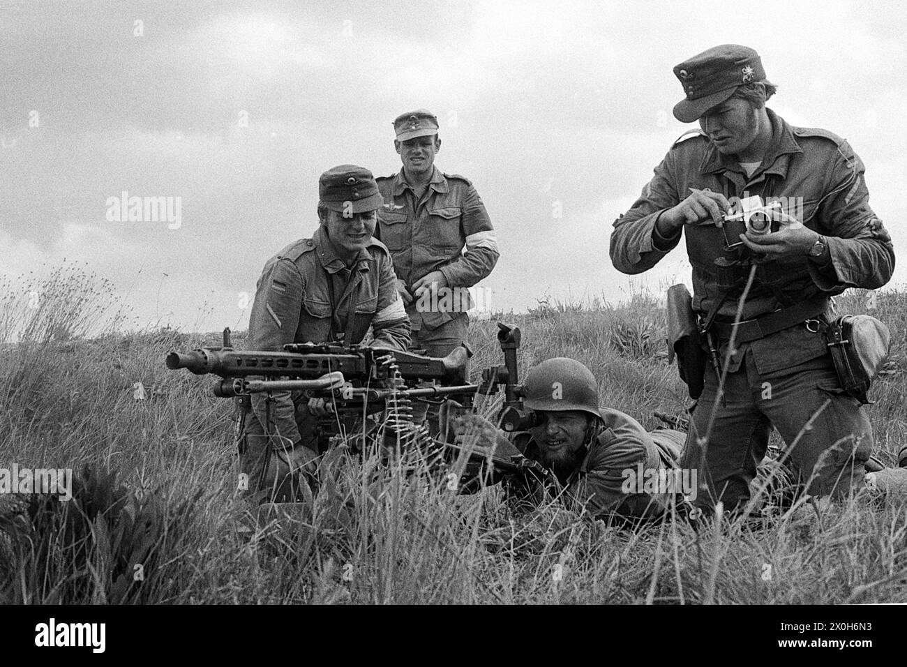 Troop exercise: While a soldier fires a G3 machine gun at a gun ...