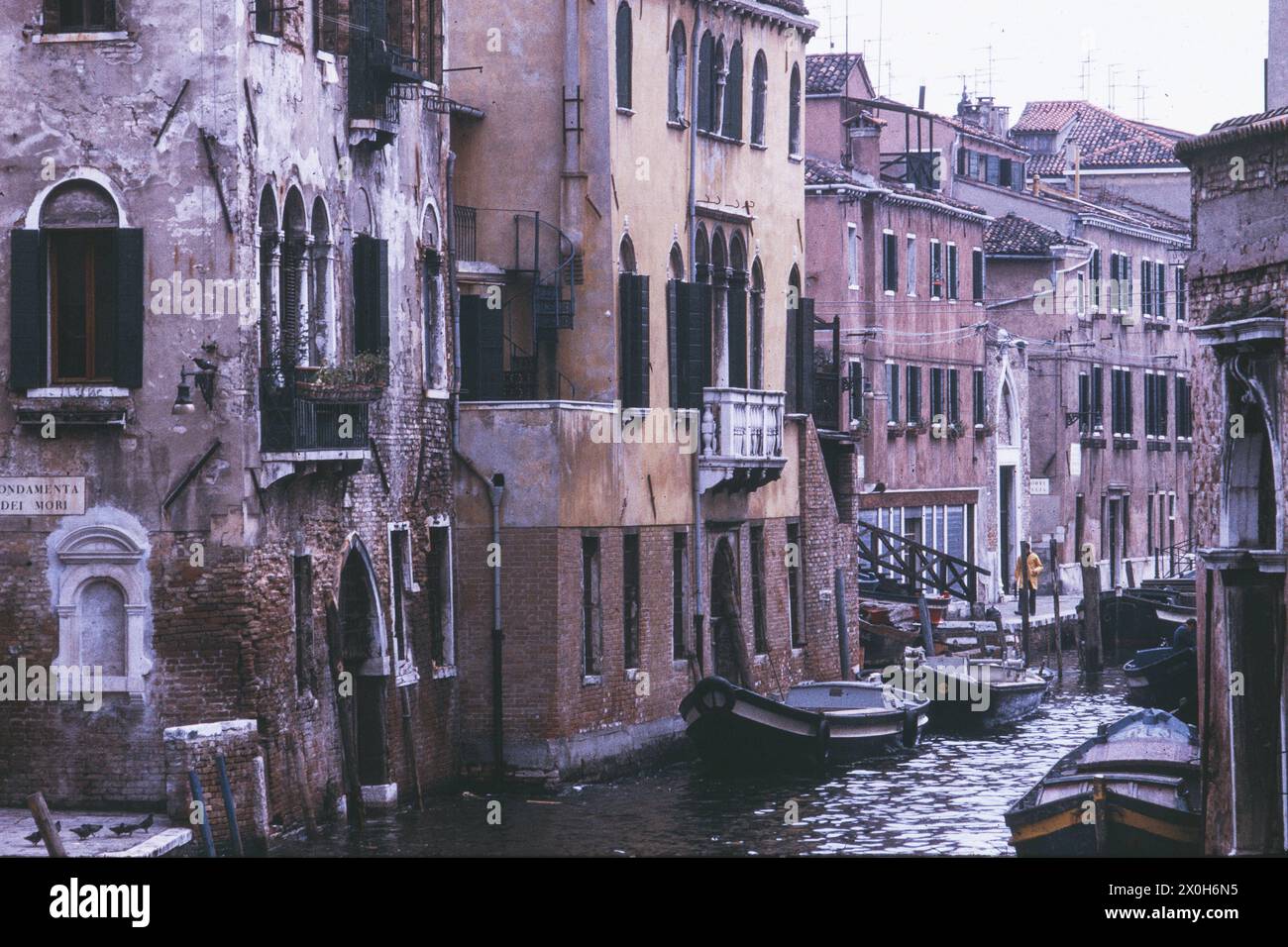 A run-down residential and working-class neighborhood along a canal in ...