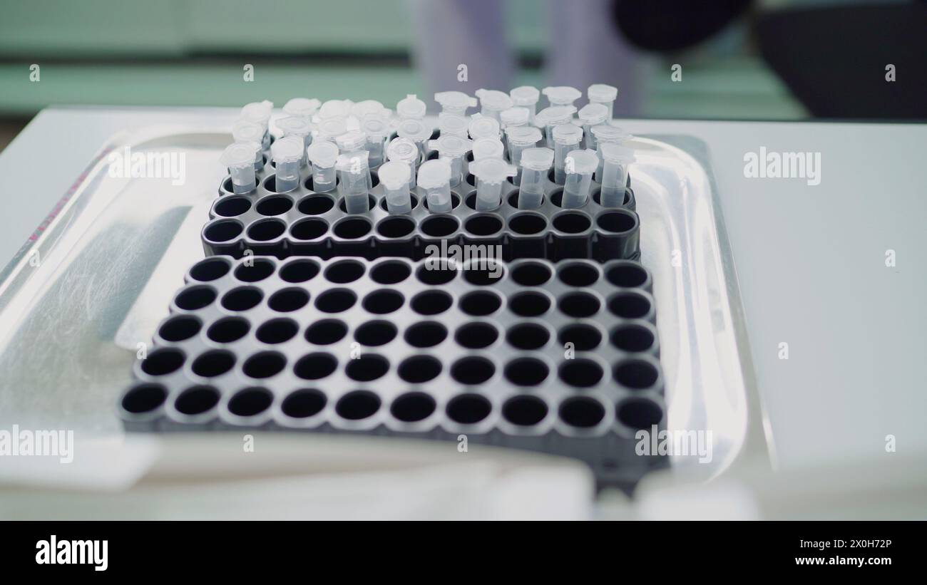 The gloved doctor takes the test tubes. Close-up of a scientist taking ...