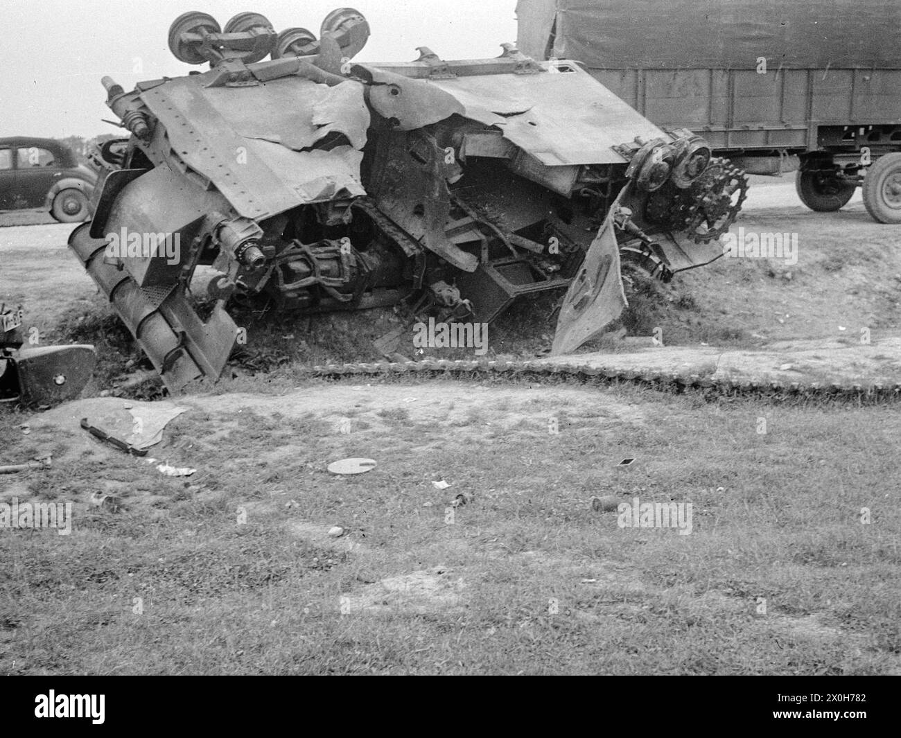 A shot-up tank lies upside down in a ditch. The picture was taken by a ...
