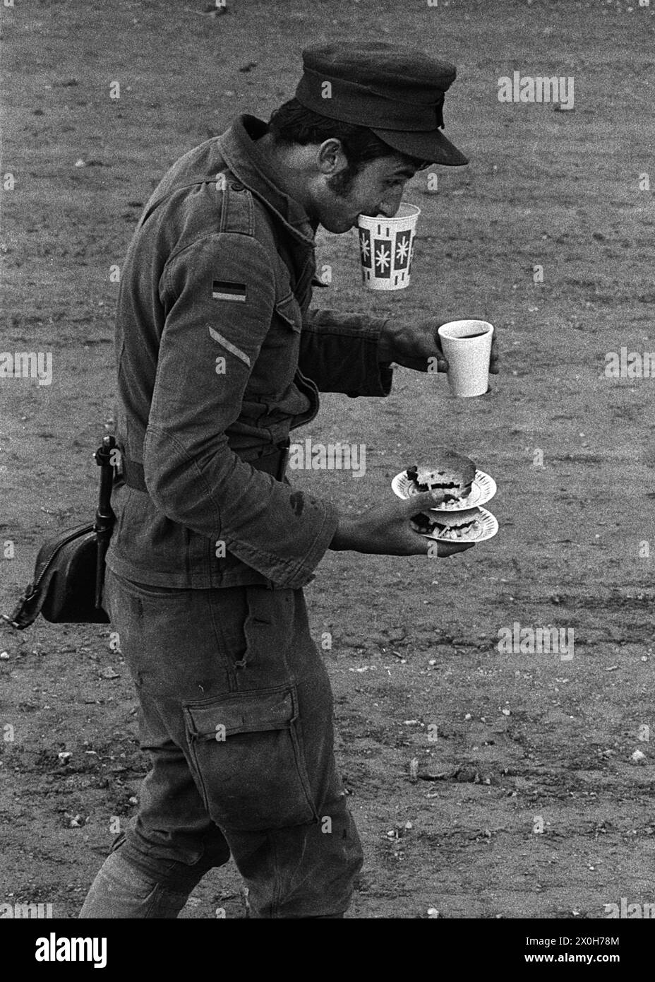Troop exercise: A soldier carries and balances the food and drink with ...