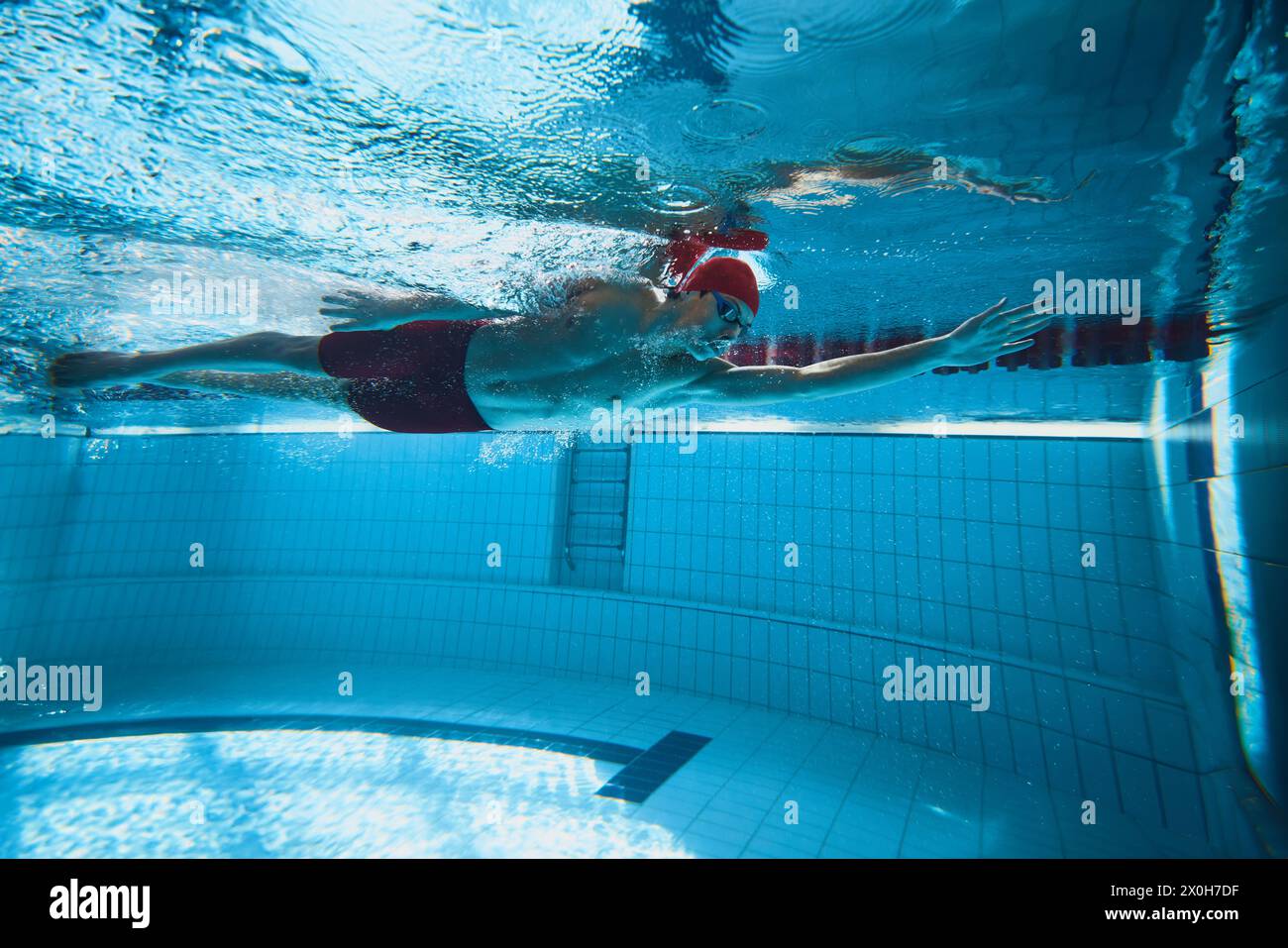 Champion. Young man, swimmer in motion in poo reaching the edge ...