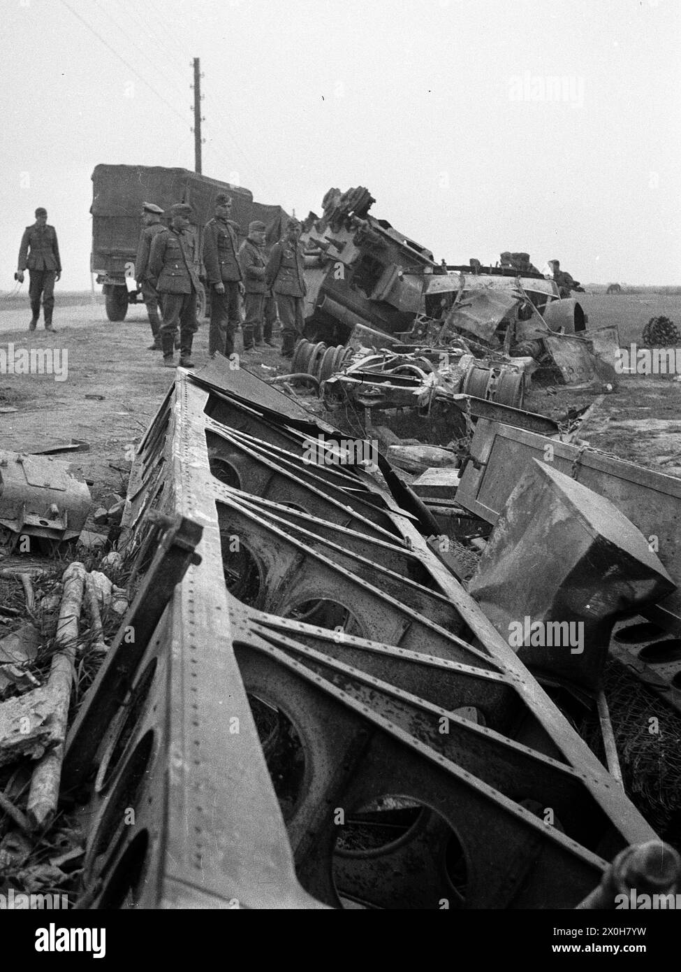 Wehrmacht soldiers inspect tanks and other vehicles shot up and burned ...