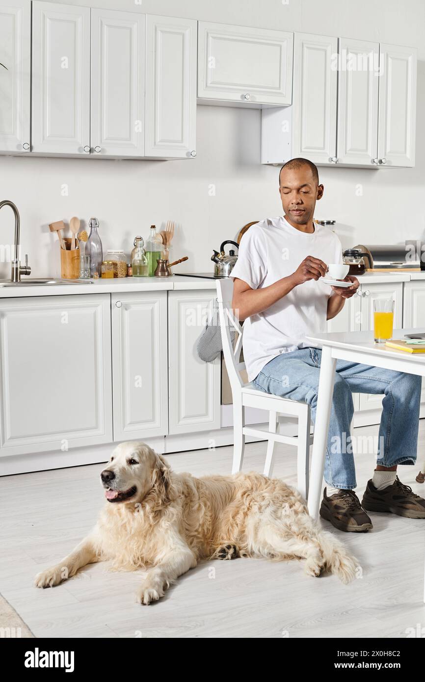 A disabled African American man sitting at a kitchen table with his ...