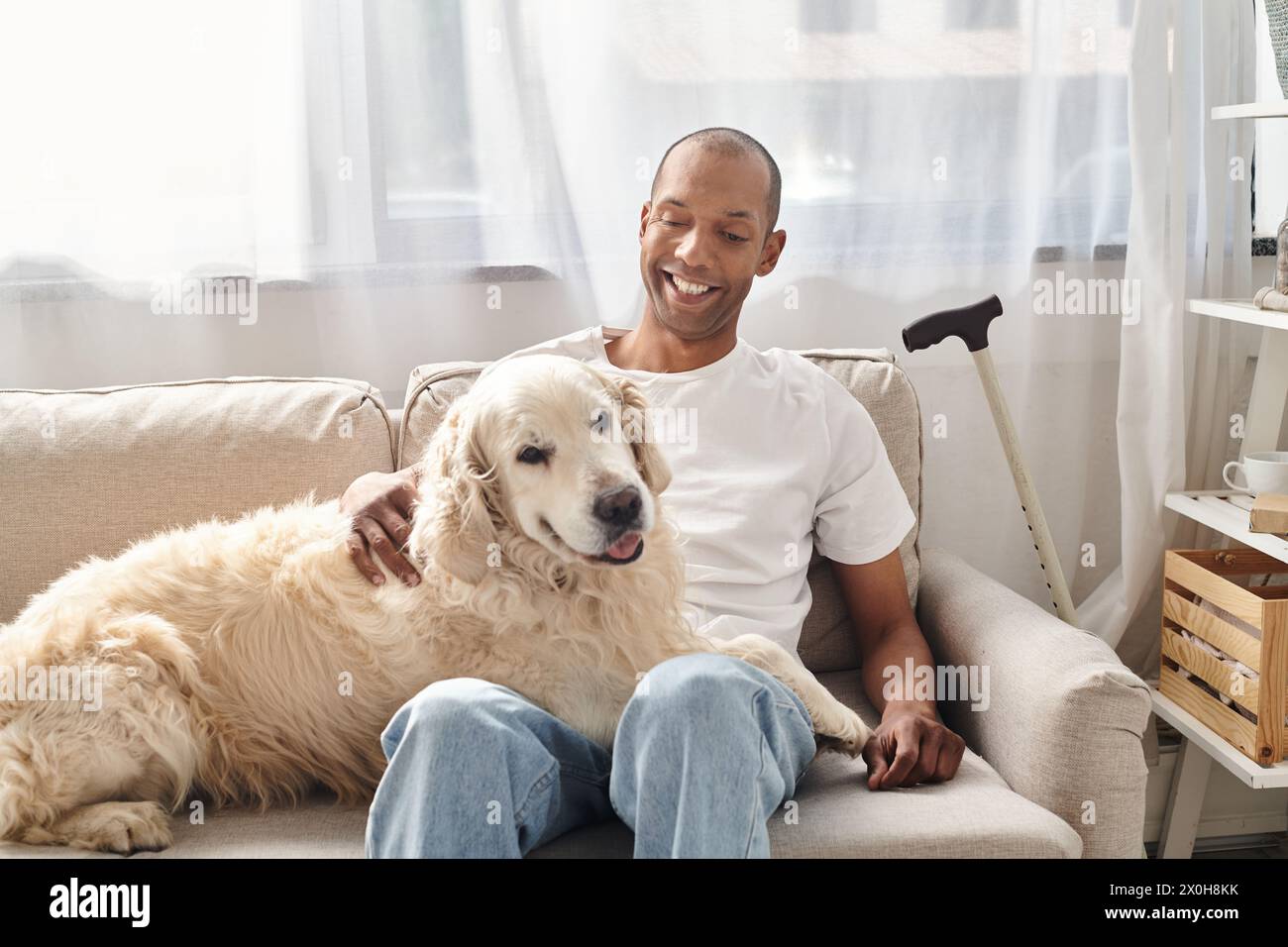 A disabled African American man with myasthenia gravis and his Labrador ...