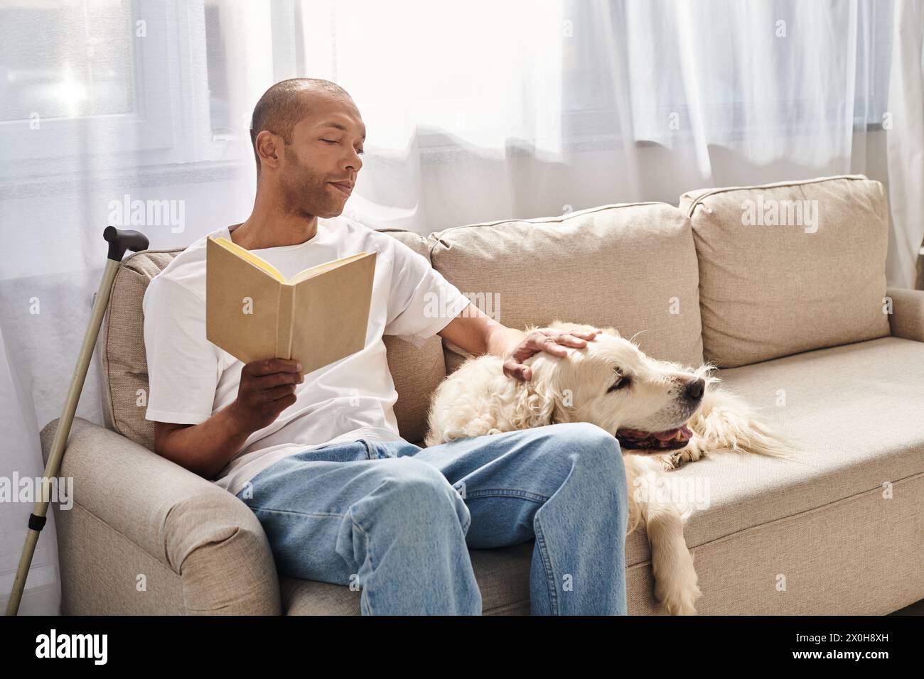 A disabled African American man with myasthenia gravis reading a book ...