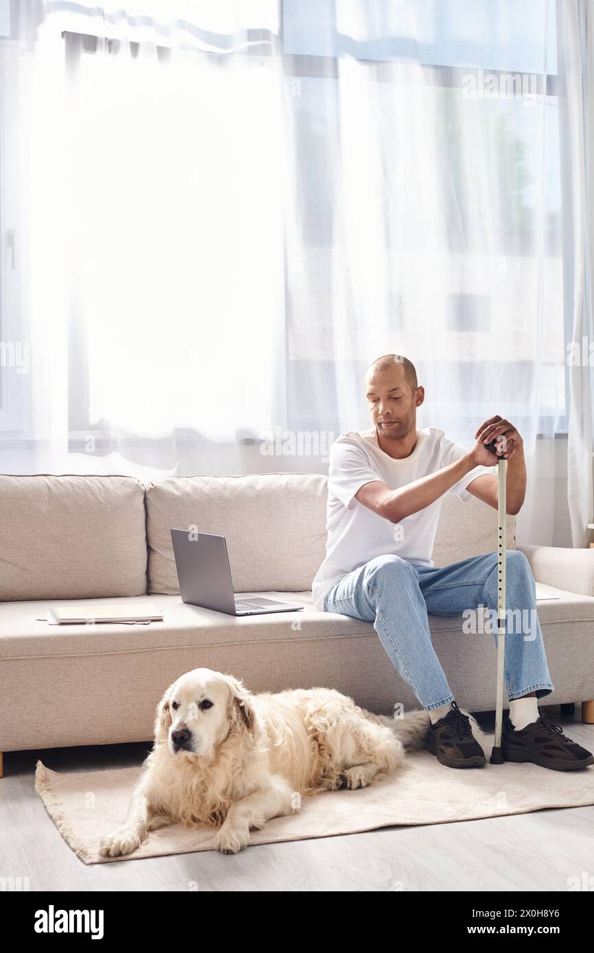 A disabled African American man relaxes beside his loyal Labrador dog ...