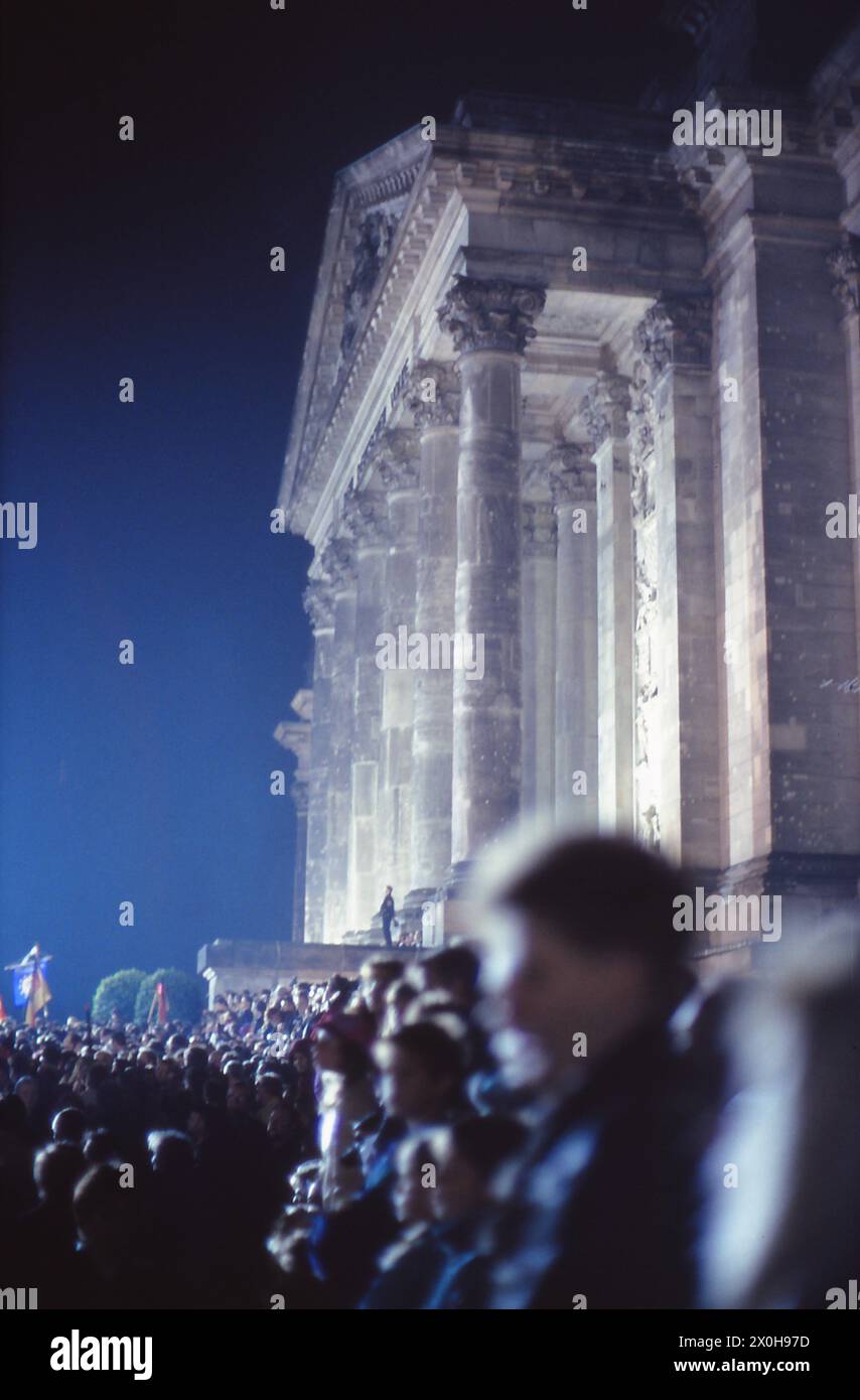 A crowd celebrates German reunification in front of the Reichstag ...