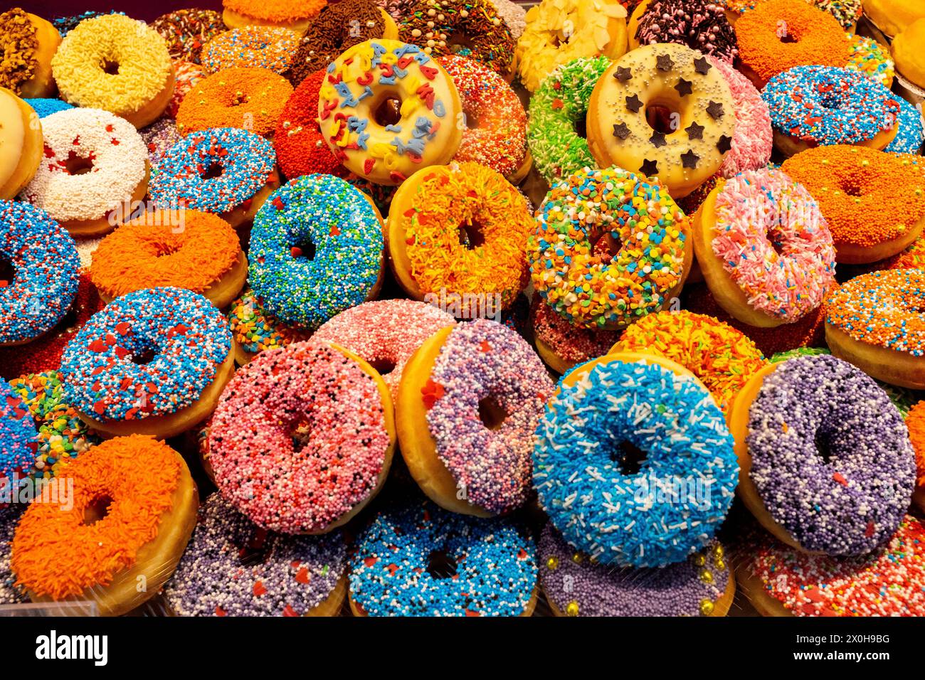 Colorful Donuts on Display for Sale Stack of very colorful donuts for ...