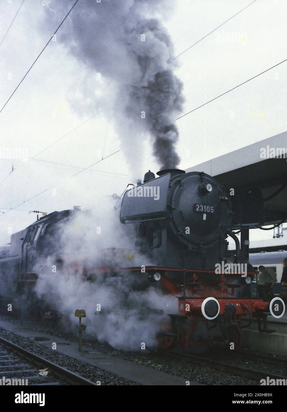 The steam locomotive BR 23 105 starts up under heavy steam development ...