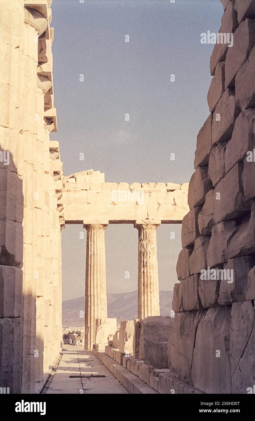 View of two columns from inside the Parthenon. Remains of a stone wall ...