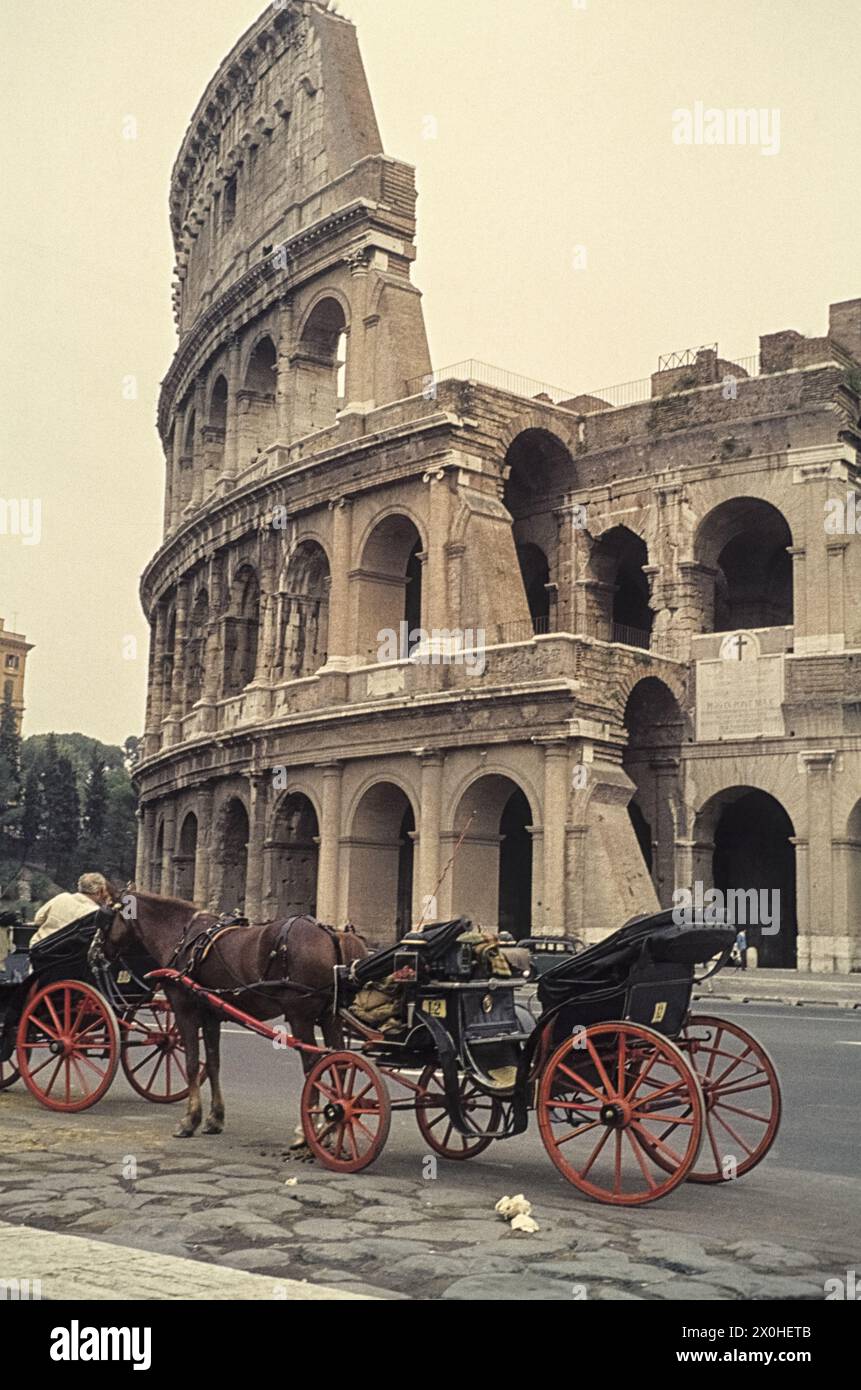 A horse-drawn carriage waits for passengers in front of the ...