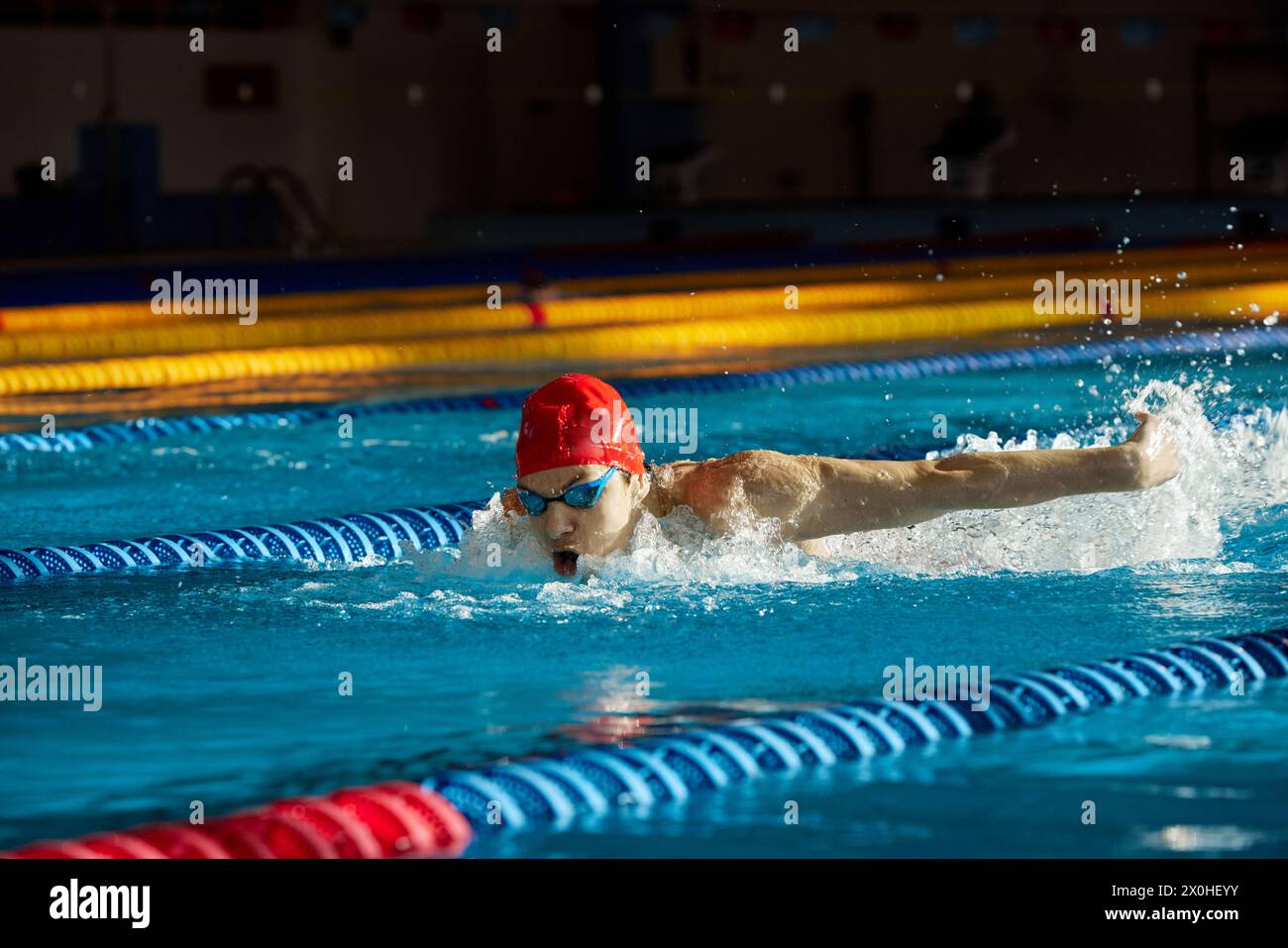Young muscular man showing competitive spirit, swimmer in cap and ...