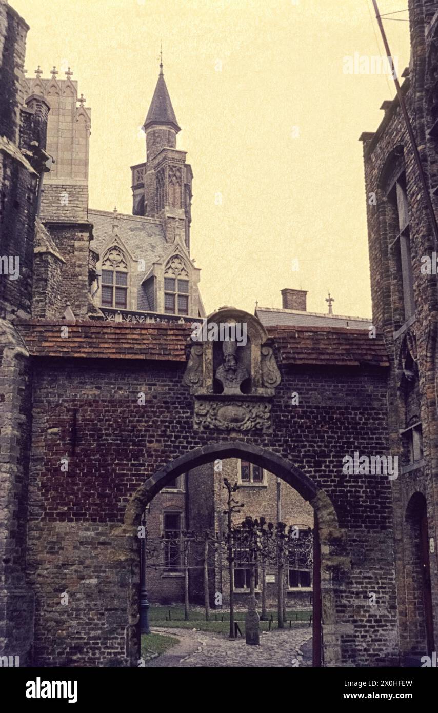 Portal with stone sculpture in the archway. Entrance to a small ...