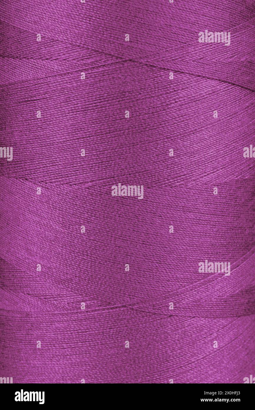 Texture of pink color threads in spool close up, macro. Sewing threads ...
