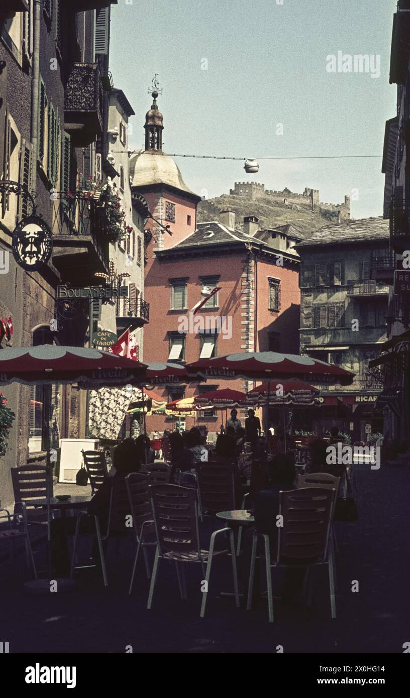 Medieval townscape In the background on the rock of the ruins of the ...