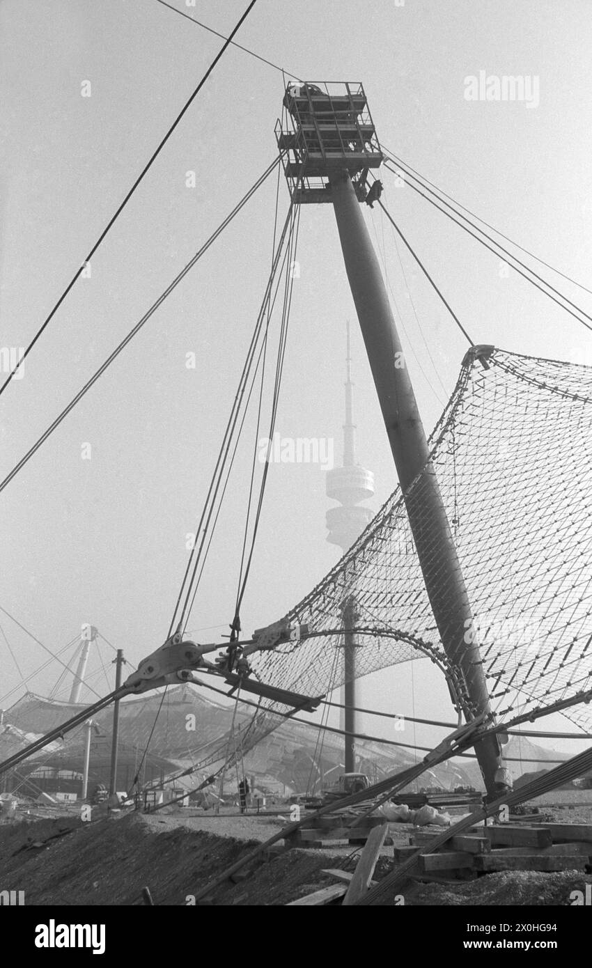 Construction site with rope supports and television tower. [automated ...