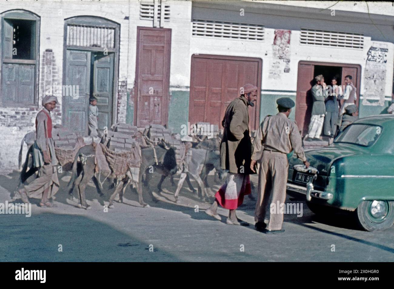 Street scene in Pakistan in 1960 with brick caravan Stock Photo - Alamy