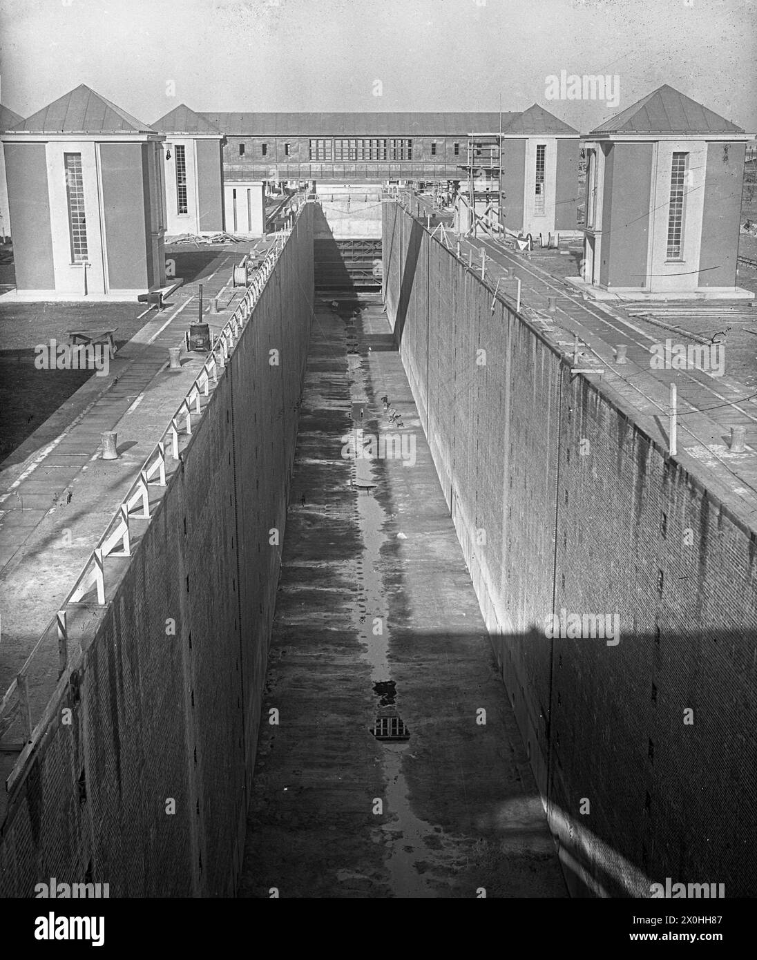 The Hindenburg Lock in Hanover just before its opening in 1928. Two men ...