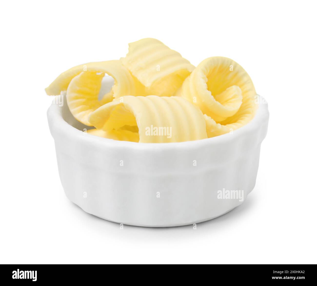 Tasty butter curls in bowl isolated on white Stock Photo - Alamy