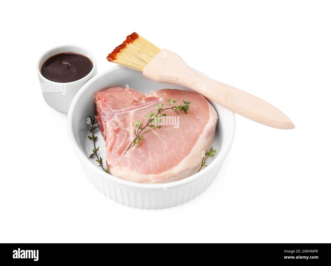Raw meat, thyme and brush with marinade isolated on white Stock Photo ...