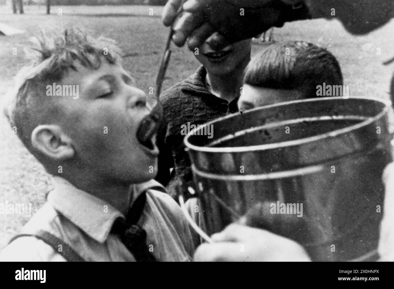 A Hitler Youth eating in a tent camp in Ochsenfurt. [automated ...