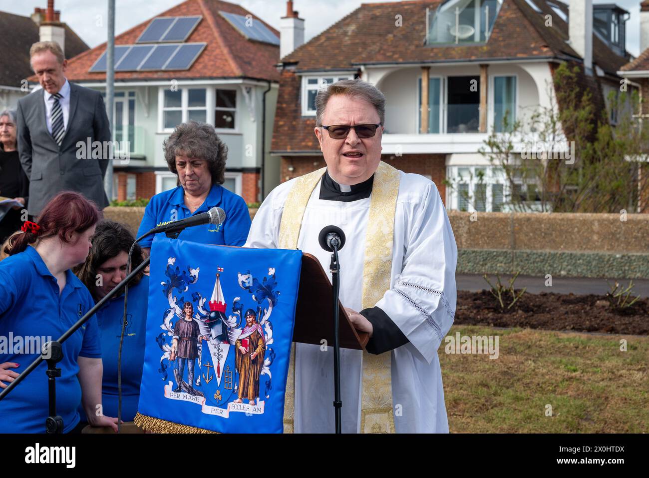 Father Jeffrey Woolnough speaking at an event to unveil a statue ...