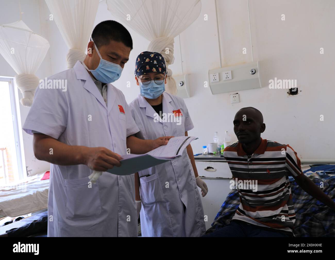 Kigali, Rwanda. 9th Apr, 2024. Zhang Heping(L) and Sun Hongmei, doctors ...