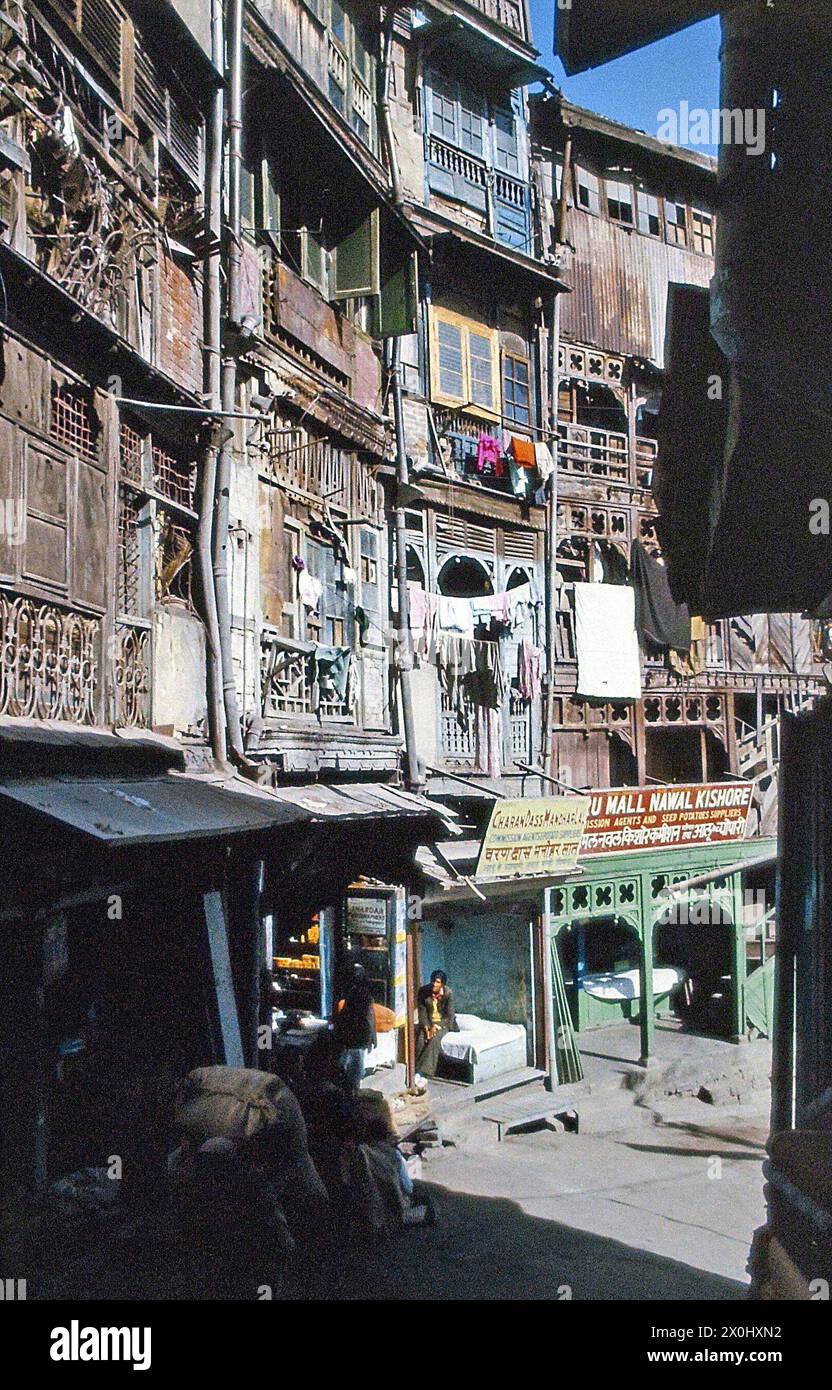 View into a narrow alley in India. The alley is left and right, narrow ...