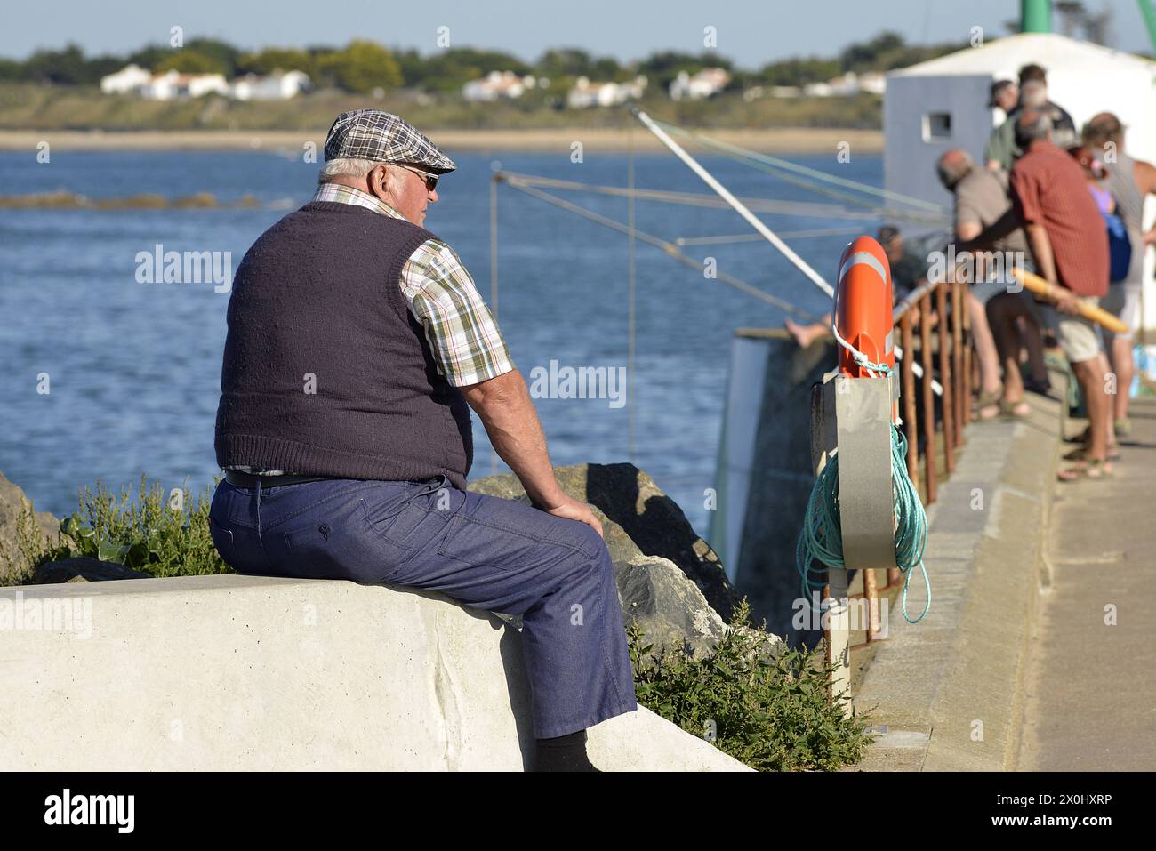 Several fishermen have put out their fishing rods at the entrance to ...