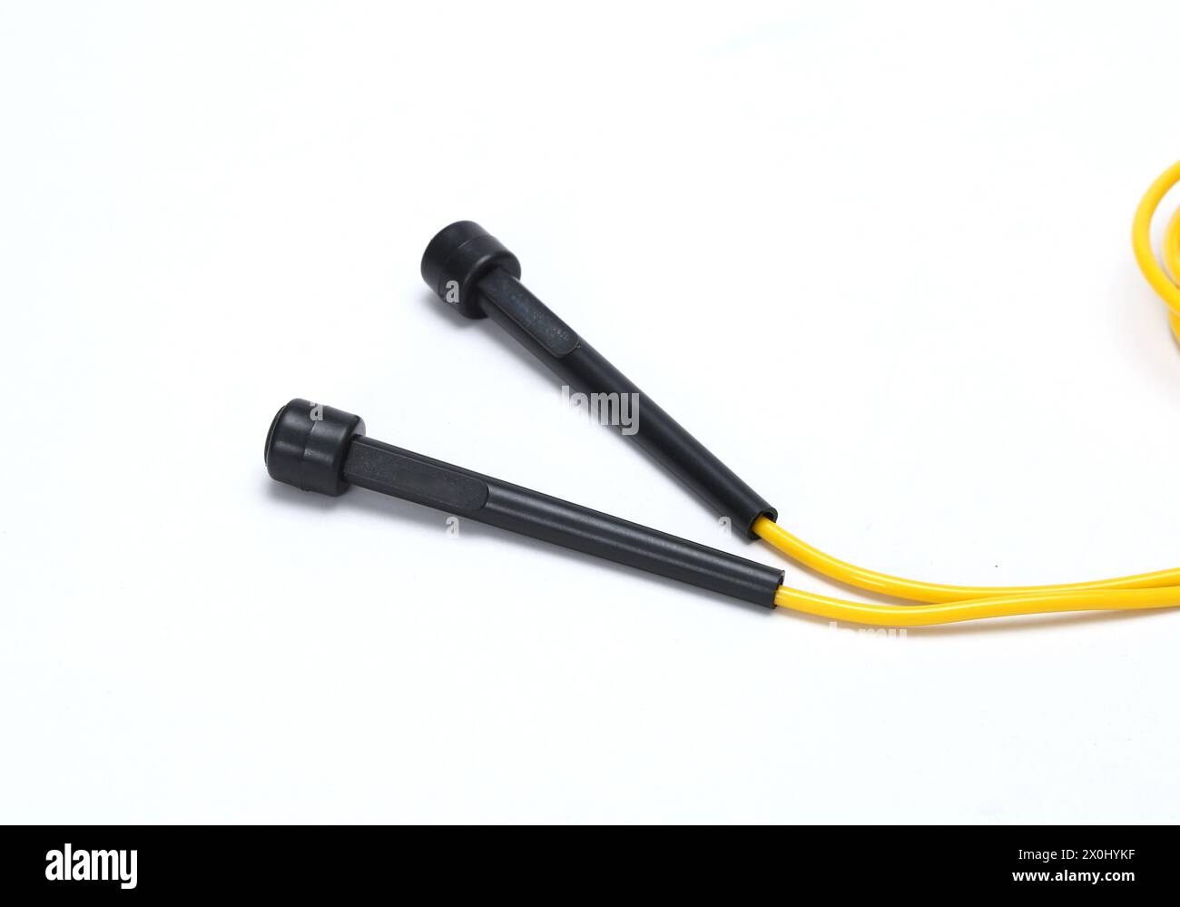 yellow black skipping rope isolated on white background Stock Photo - Alamy