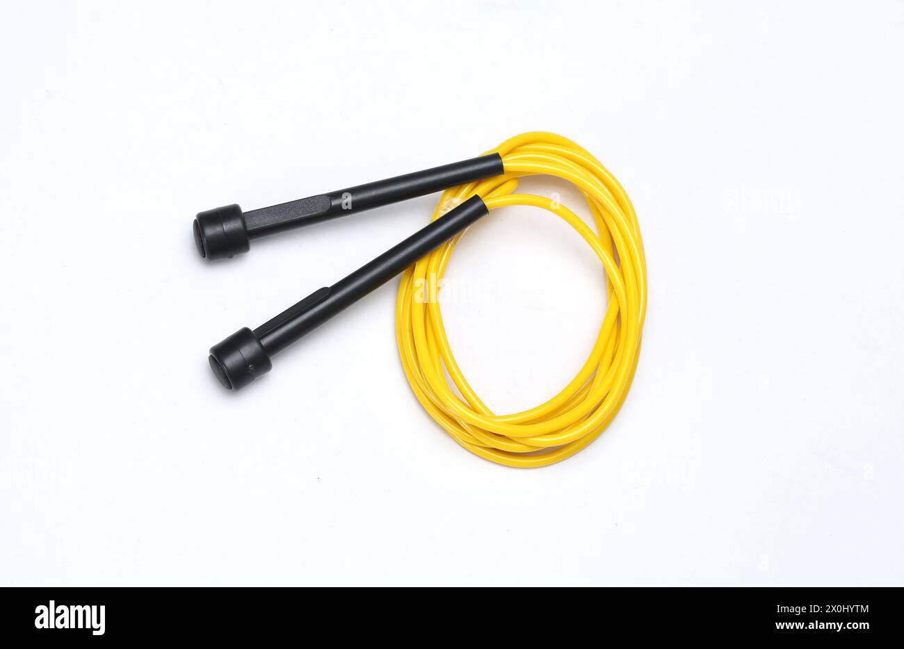 yellow black skipping rope isolated on white background Stock Photo - Alamy