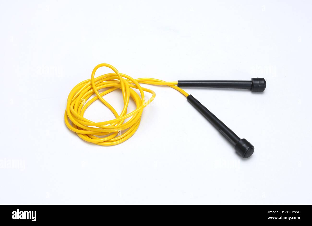 yellow black skipping rope isolated on white background Stock Photo - Alamy