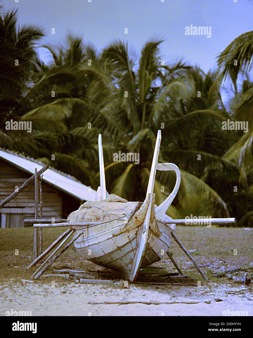 A wooden boat is lying on the stand in Malaysia. the interior is ...
