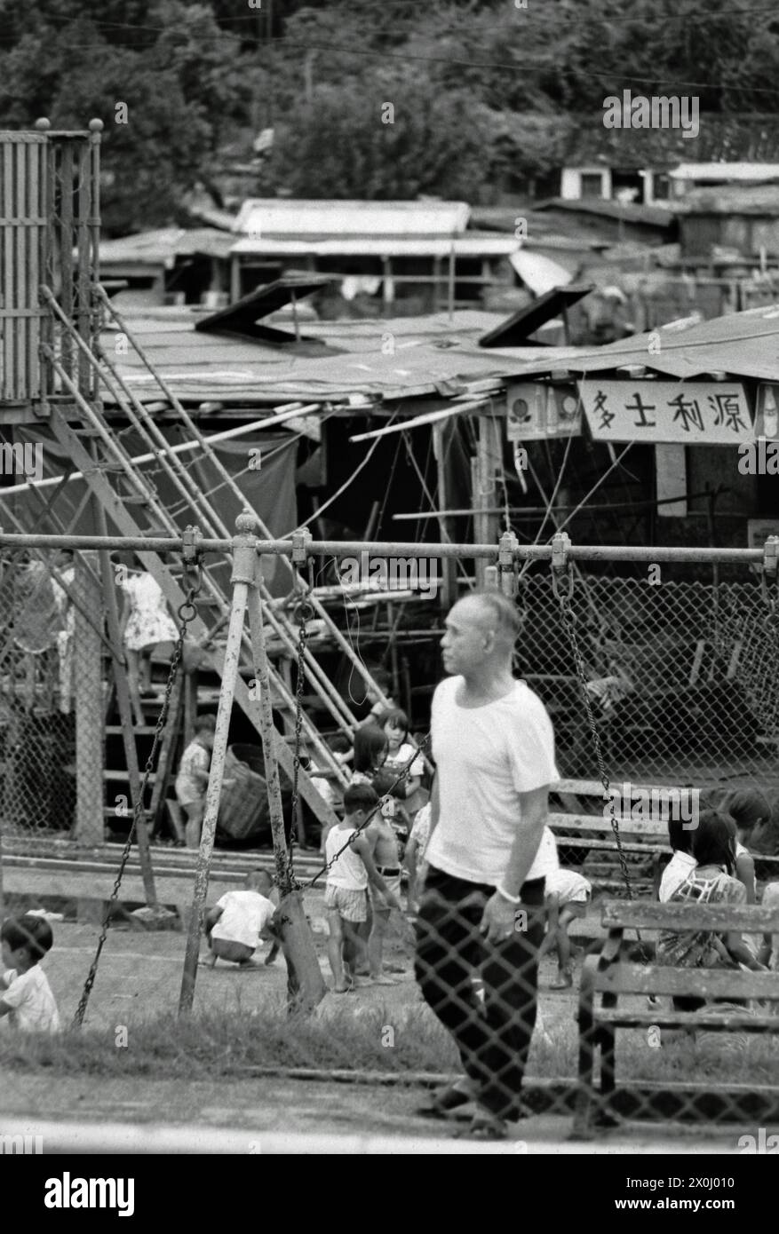 A playground in Hong Kong. Many children play on it. In the foreground ...