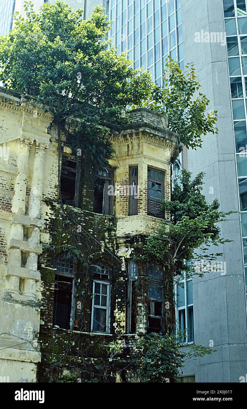 A vacant apartment building in Singapore. The facade is old and run ...