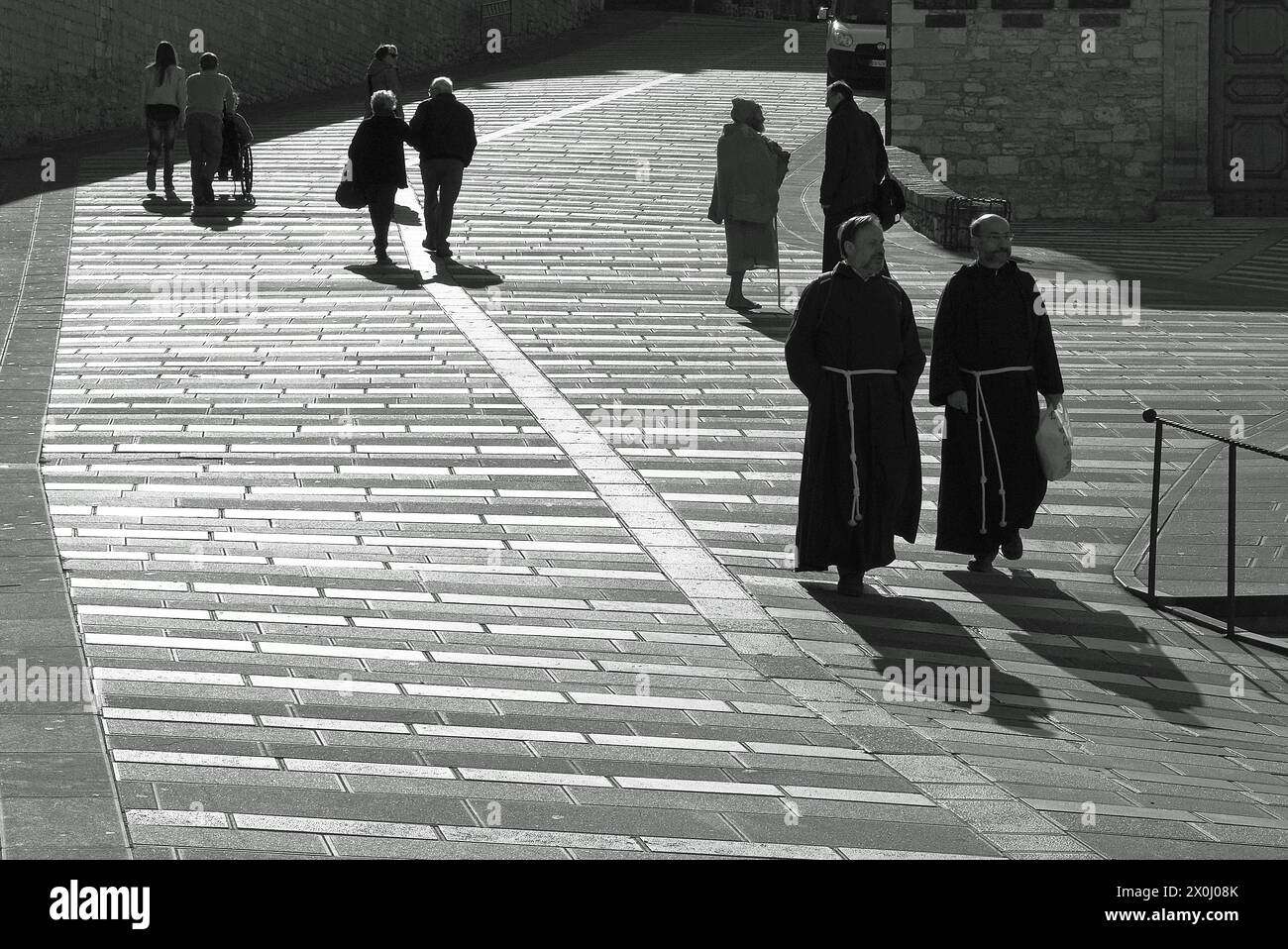 Two Franciscan friars walking in the morning sun of Assisi [automated ...