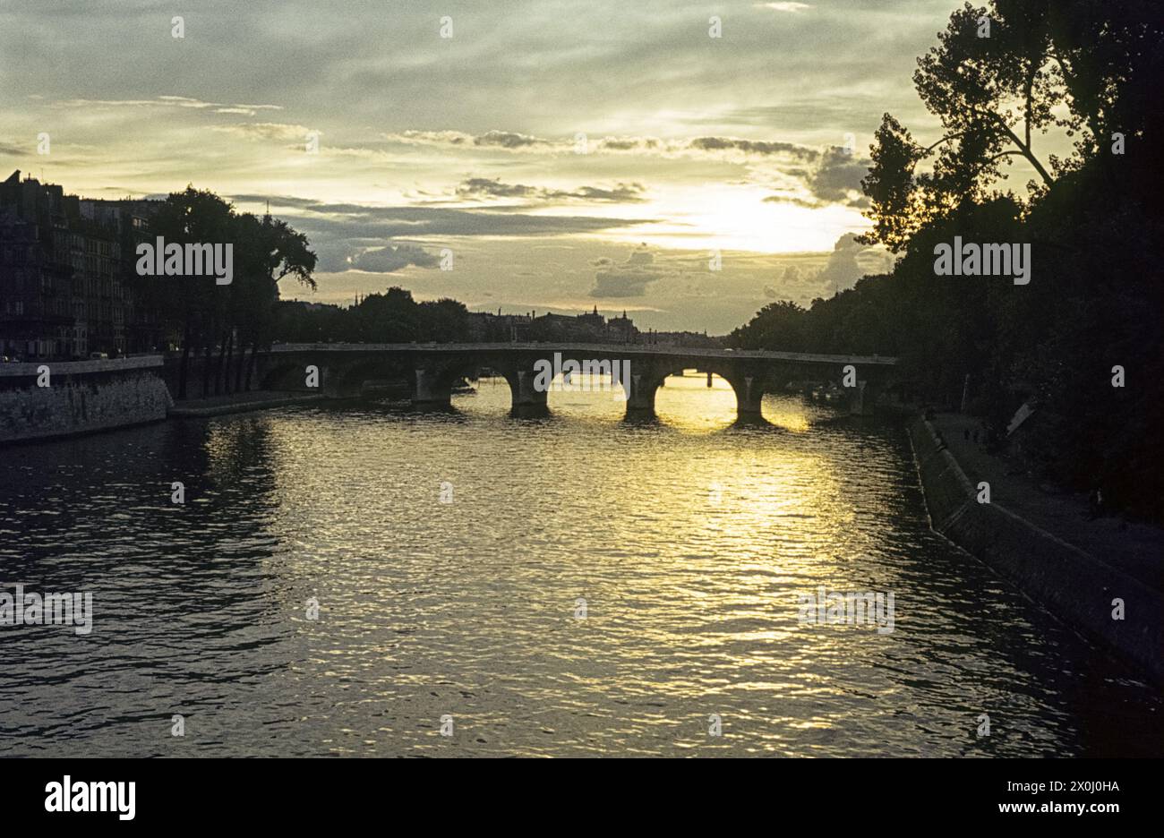 Picturesque view over the Seine and its bridges into the setting sun ...