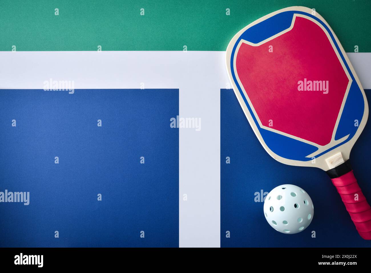 Pickleball background with wooden blue and pink racket with white ball ...