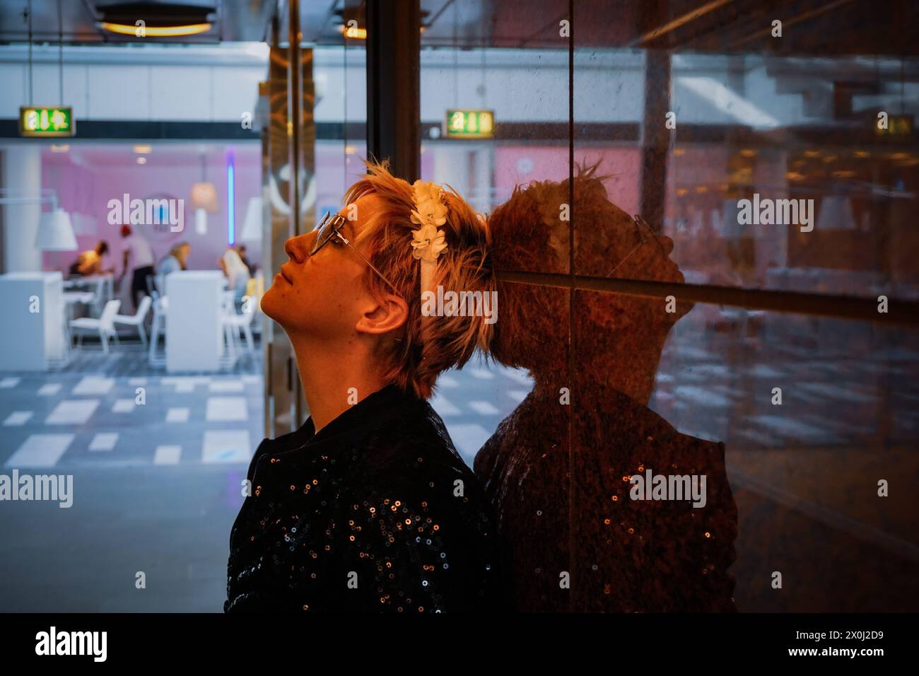 Woman leaning against glass window hi-res stock photography and images ...