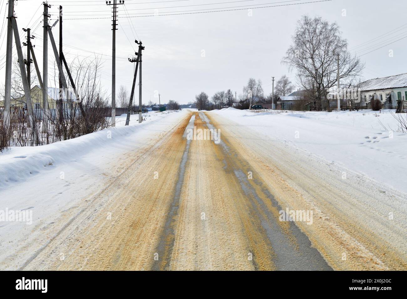 Rural winter a oad sprinkled with sand against ice Stock Photo - Alamy