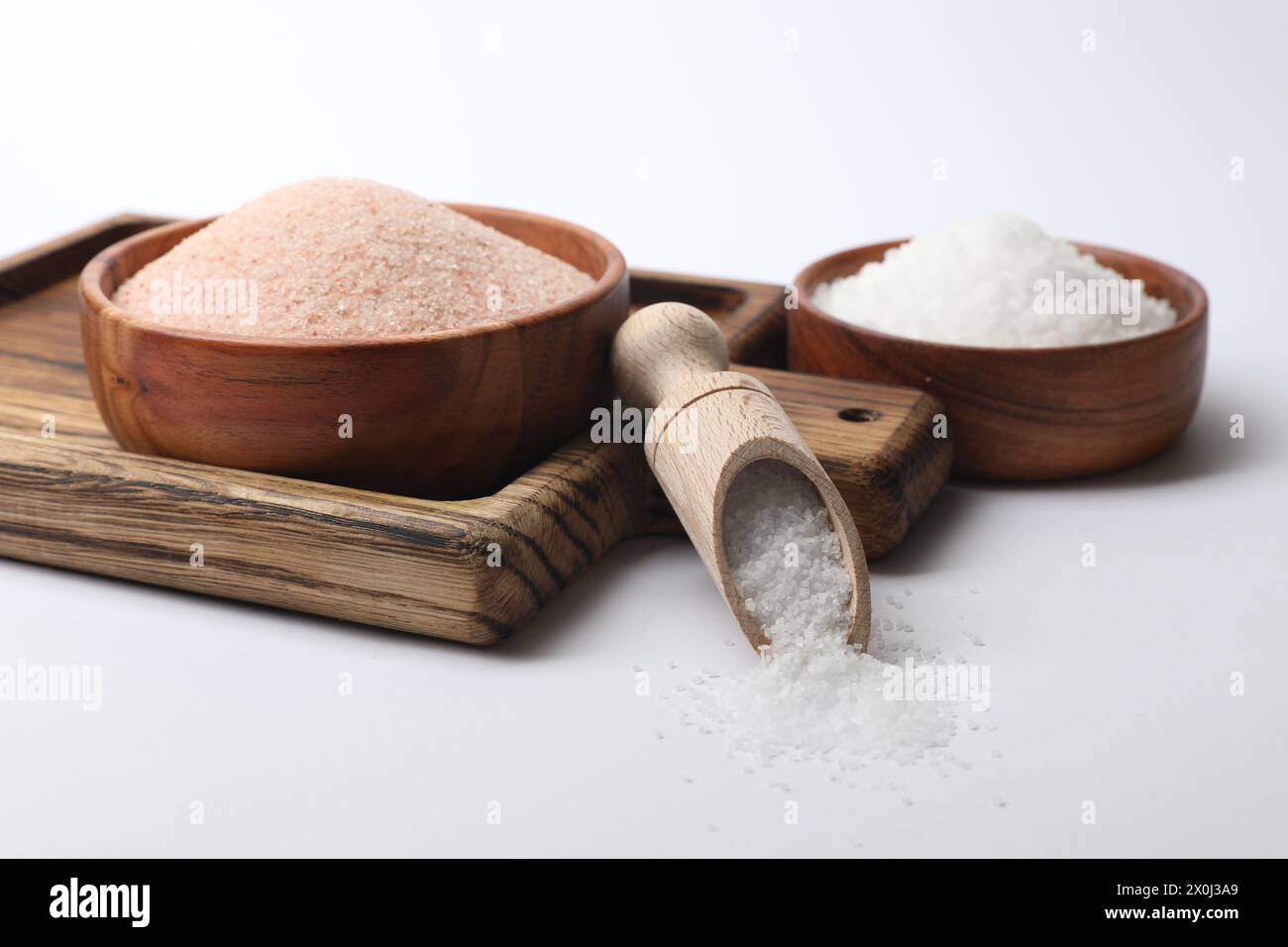 Different types of natural salt on white background Stock Photo - Alamy