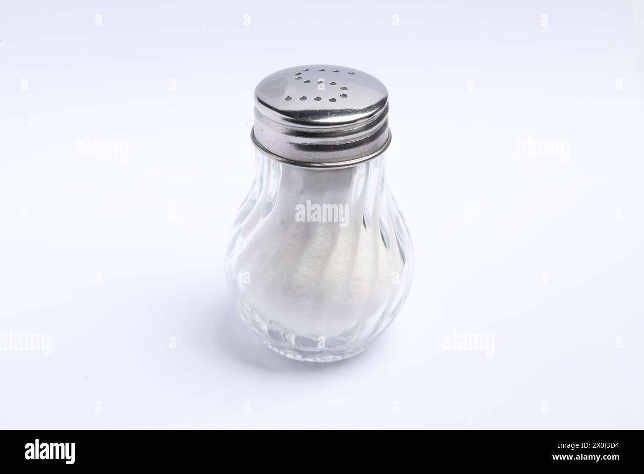 Natural salt in shaker on white background Stock Photo - Alamy