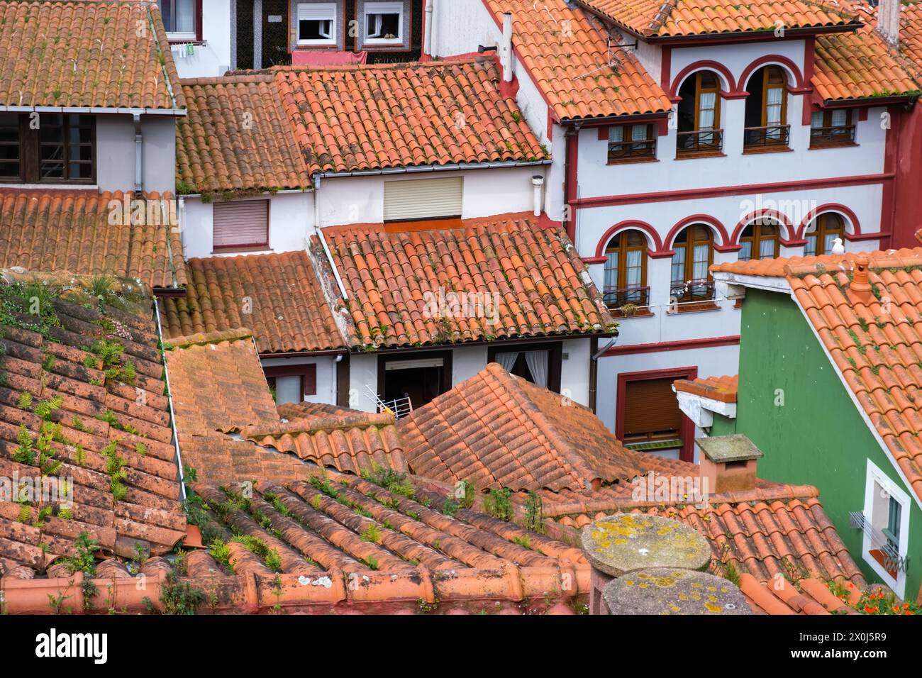 A group of buildings with red and white roofs clustered together in the ...
