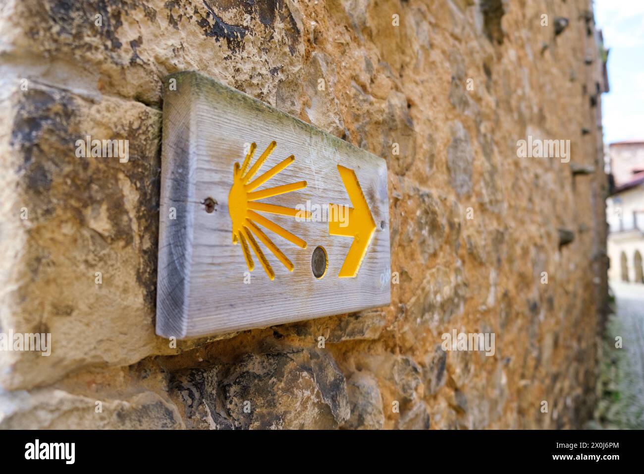 A sign is mounted on the side of a sturdy stone building, indicating ...